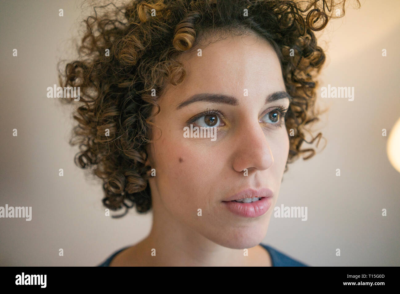 Portrait of serious woman looking sideways Stock Photo - Alamy