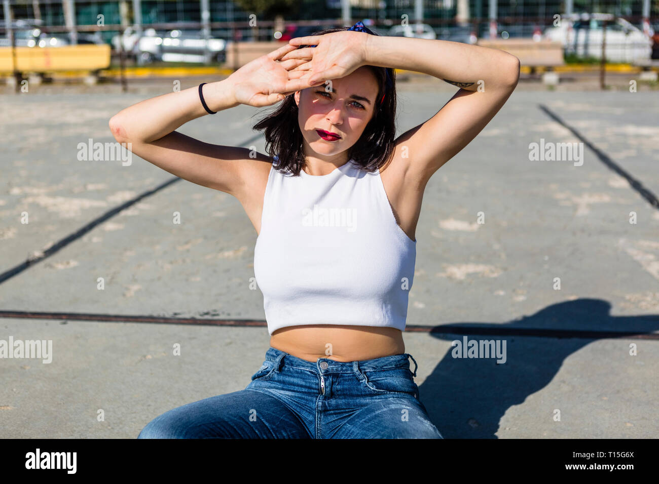 Portrait of beautiful young woman shielding her eyes Stock Photo - Alamy