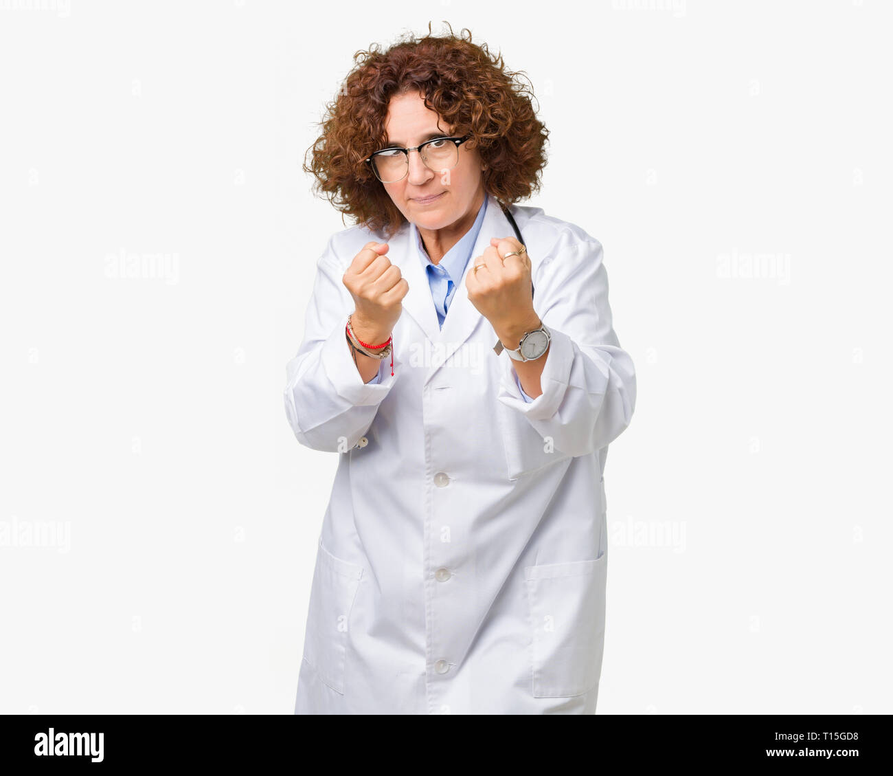 Middle ager senior doctor woman over isolated background Ready to fight ...