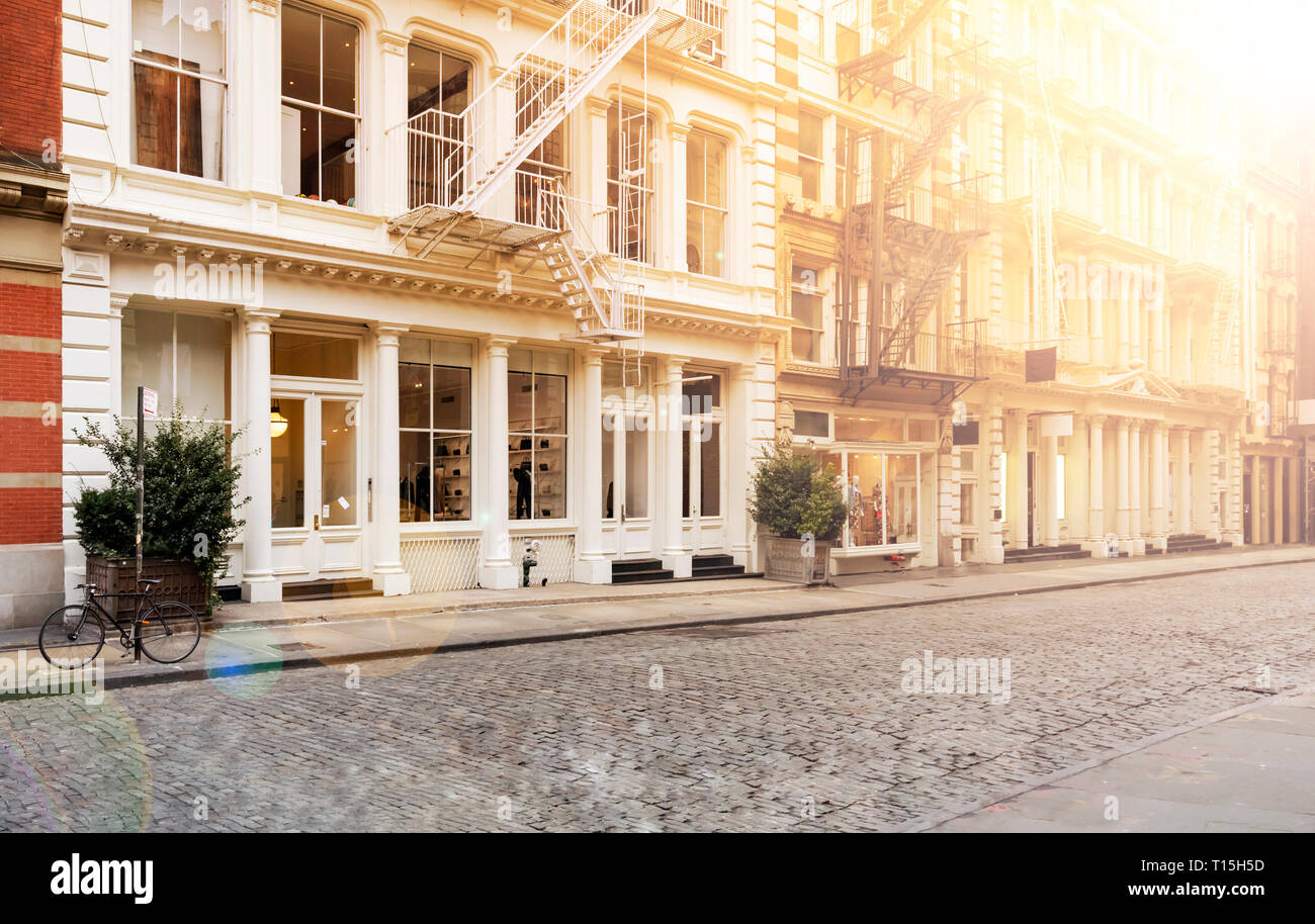 Sunlight shines on the empty sidewalks along cobblestone covered Greene ...