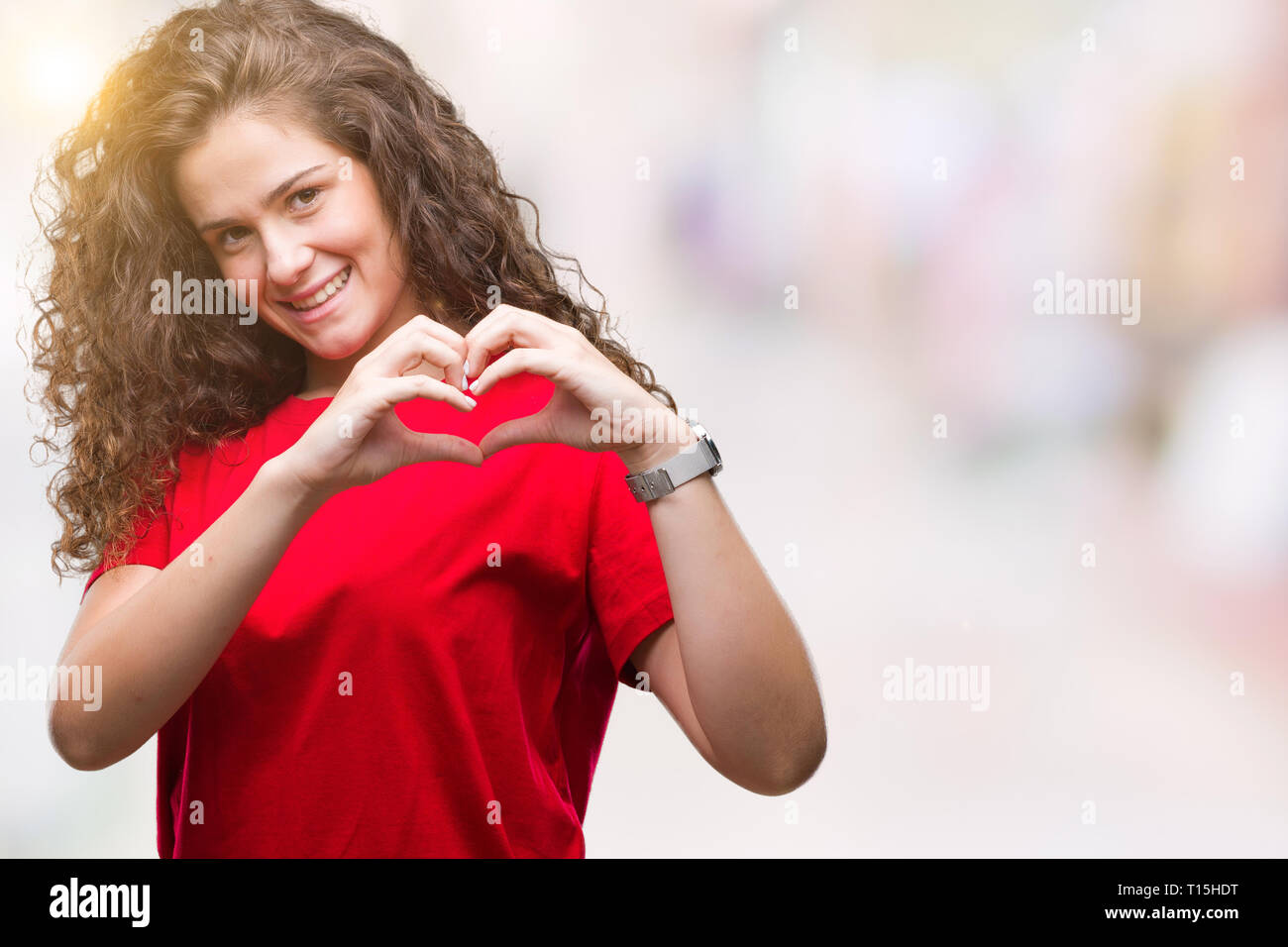 Beautiful brunette curly hair young girl wearing casual look over ...