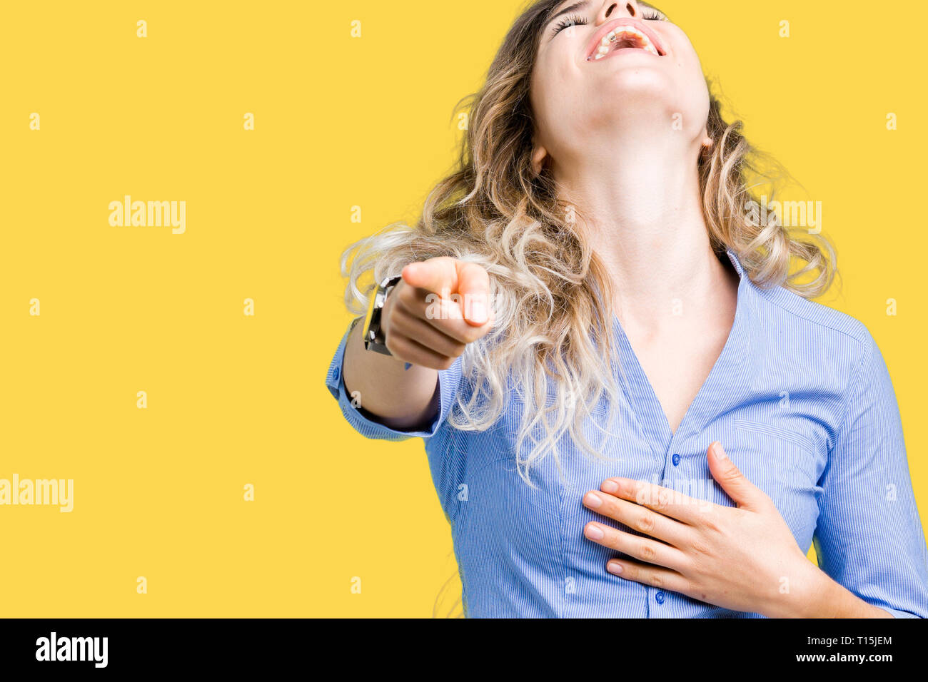 Beautiful young blonde business woman over isolated background Laughing ...