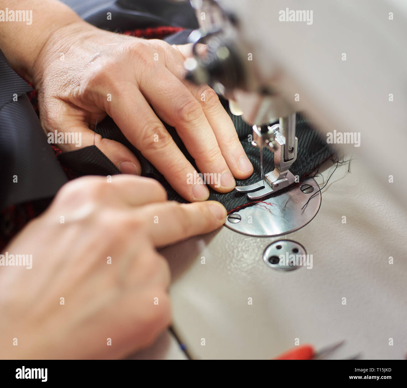 Top view of woman hands stitching garment on professional sewing ...