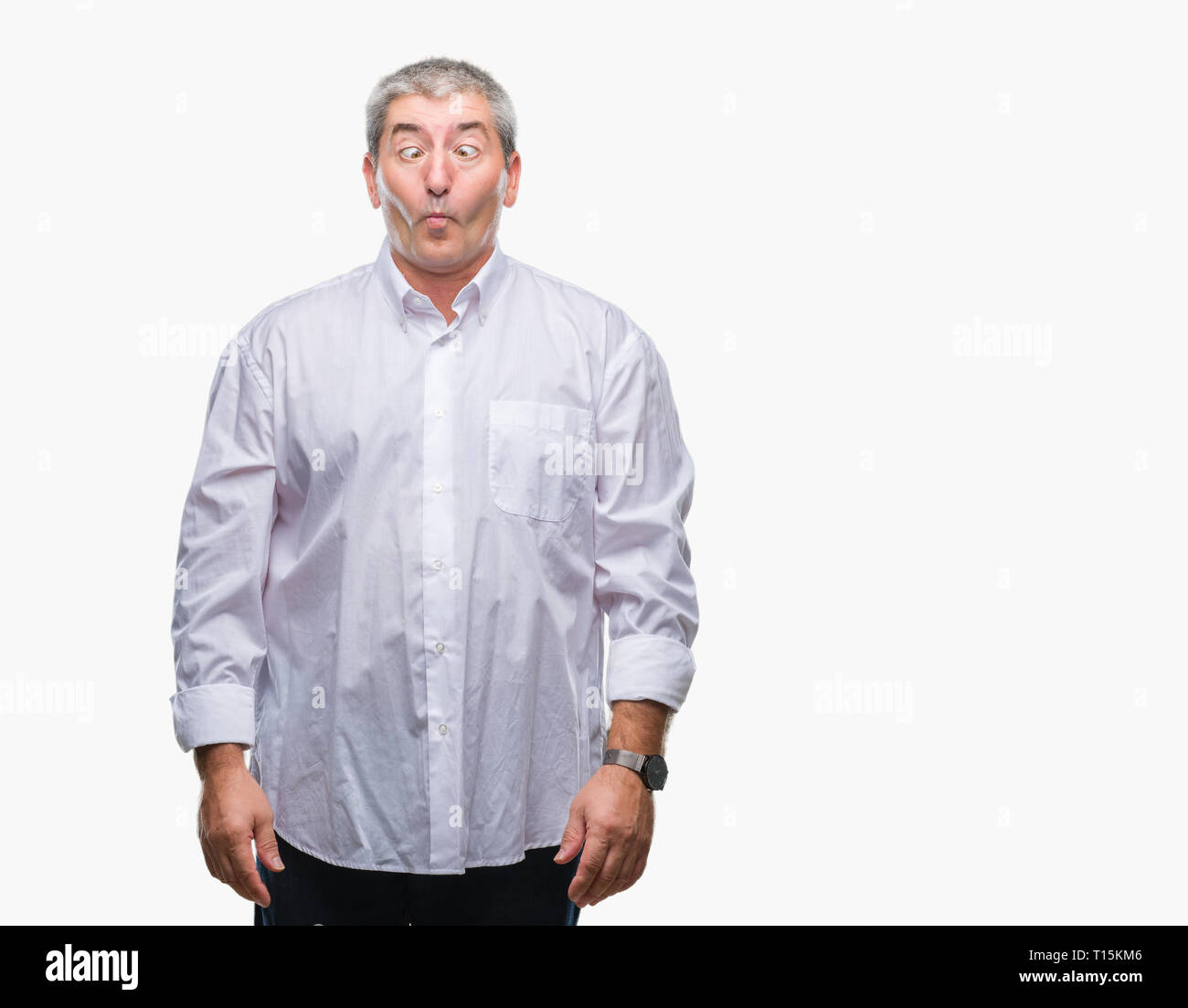 Handsome senior man over isolated background making fish face with lips ...