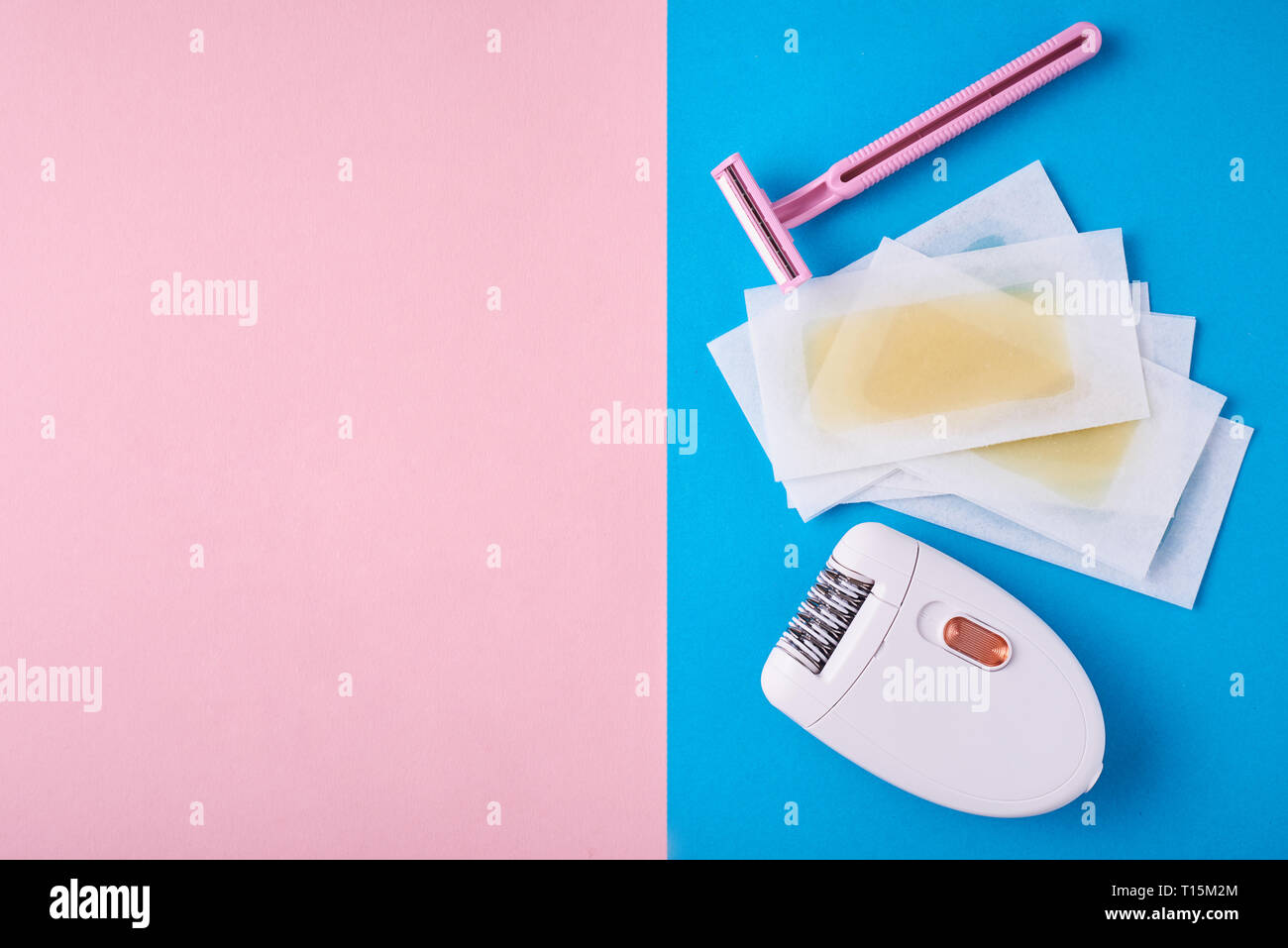 Epilator, razor for shaving and wax strips on blue and pink background ...