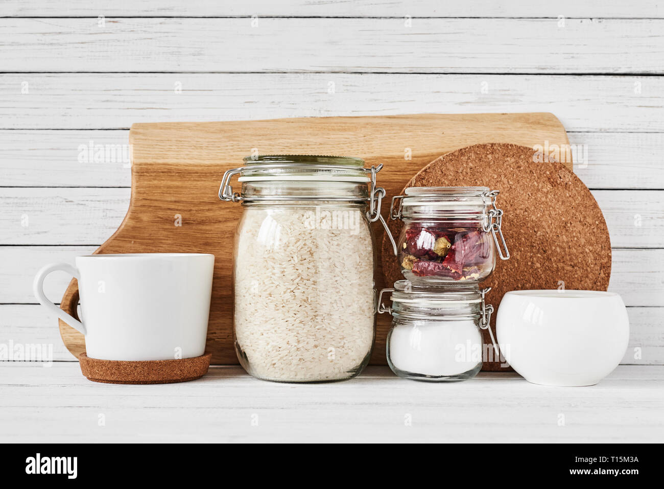 Kitchen tools and cutting board on white table, front view. Kitchen ...