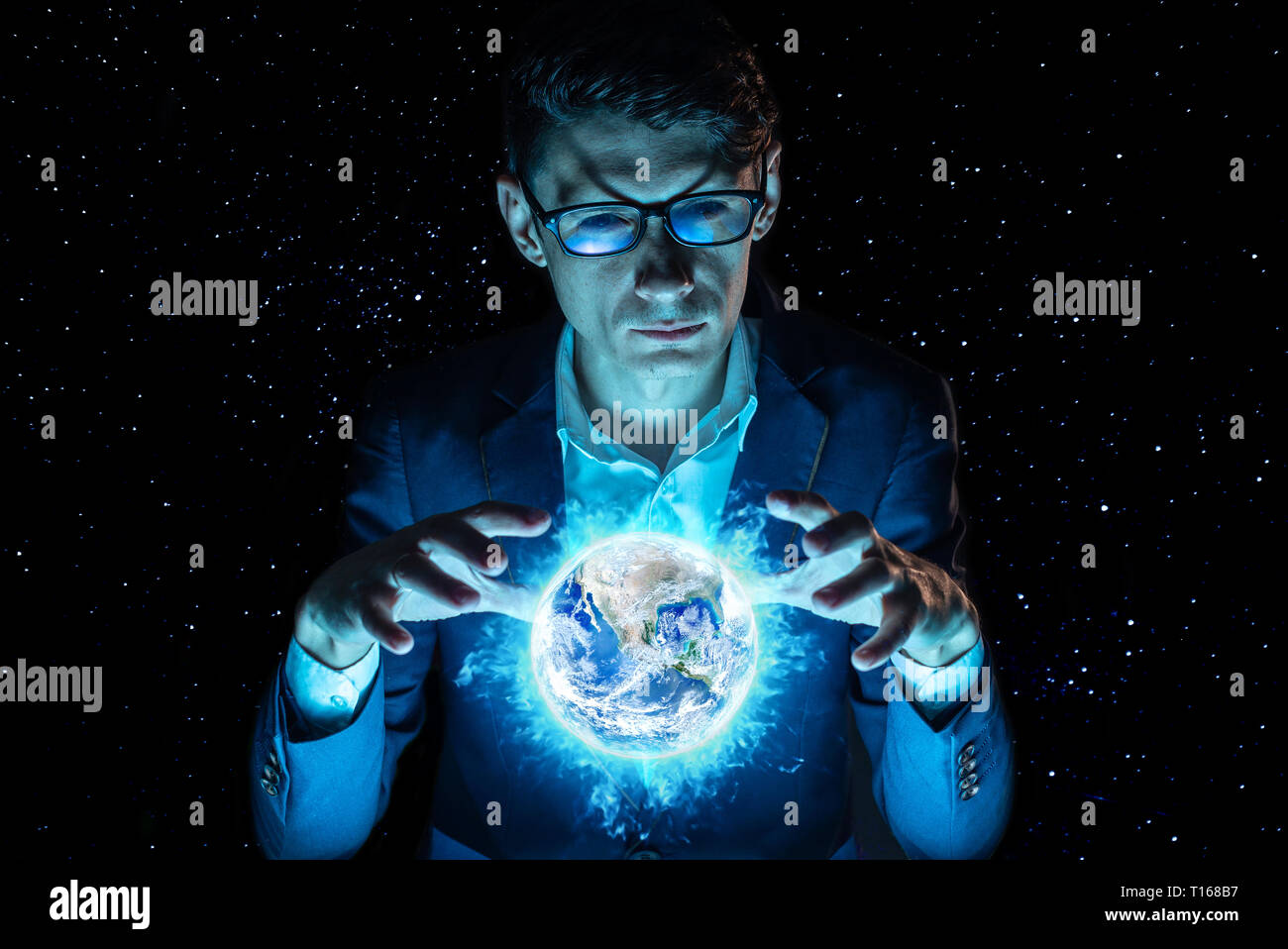 A man businessman holding hands over a blue glowing sphere in the form of planet earth. Elements ...