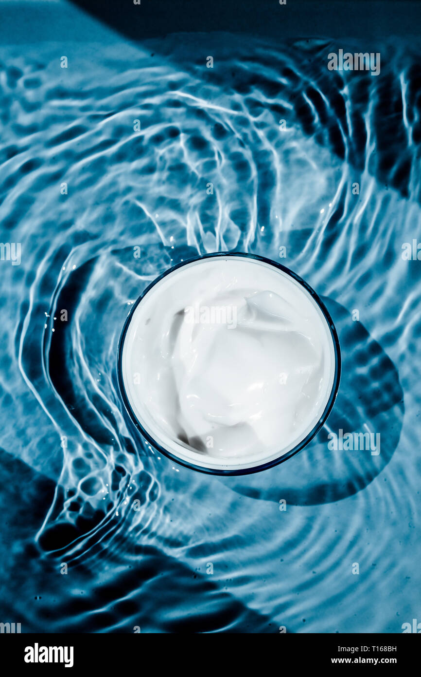 Sensitive skincare moisturizer cream on water background - clean beauty ...