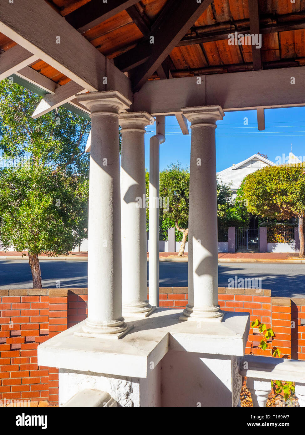 Three white columns on a verandah feature of a residential house in ...