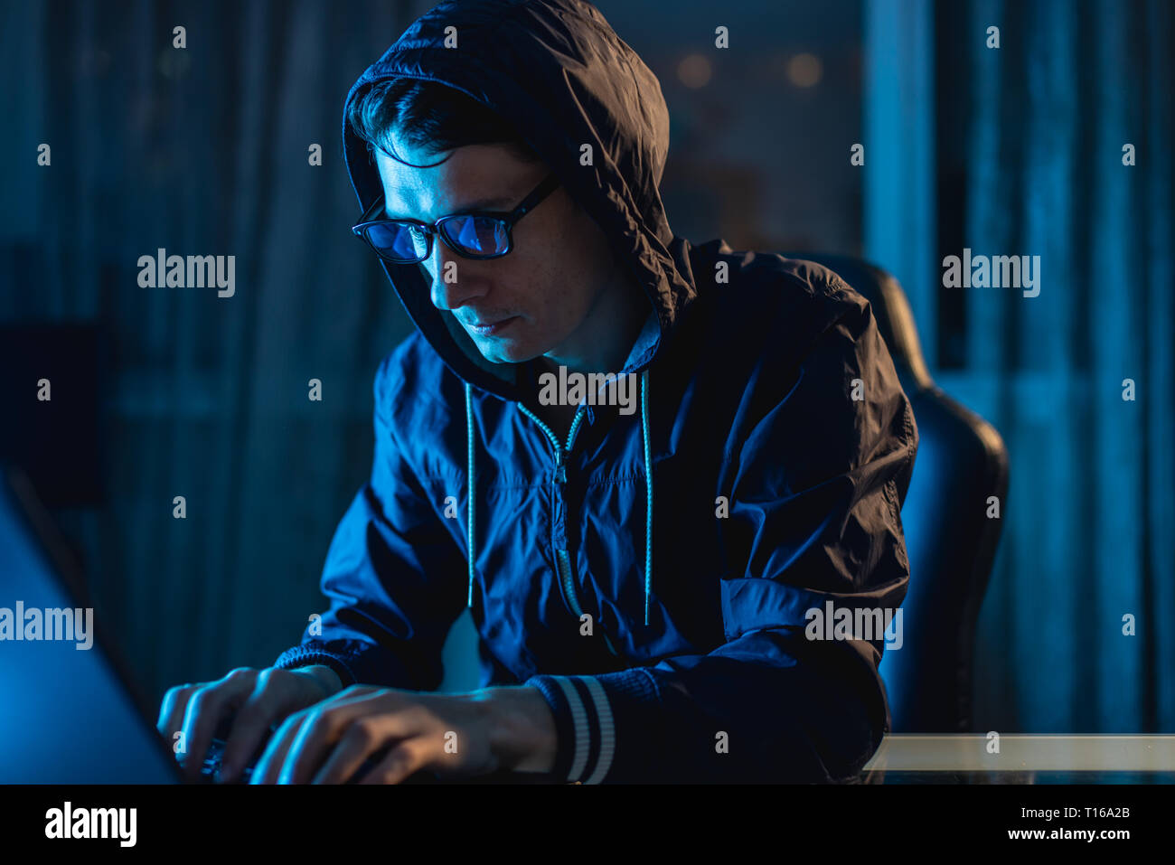 Cybercriminal Hacker In The Hood Typing Program Code While Stealing Access Databases With 