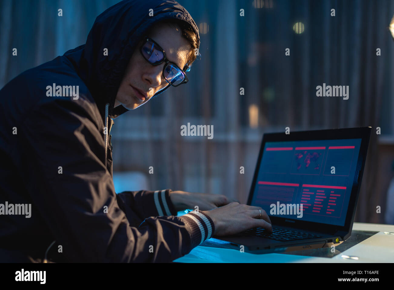 Man In The Hood Looking In The Camera Hacker Attacks And Stealing Access Databases With