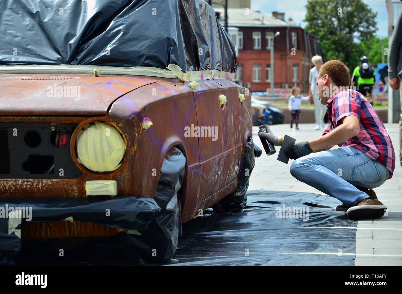 A young red-haired graffiti artist paints a new colorful graffiti on ...