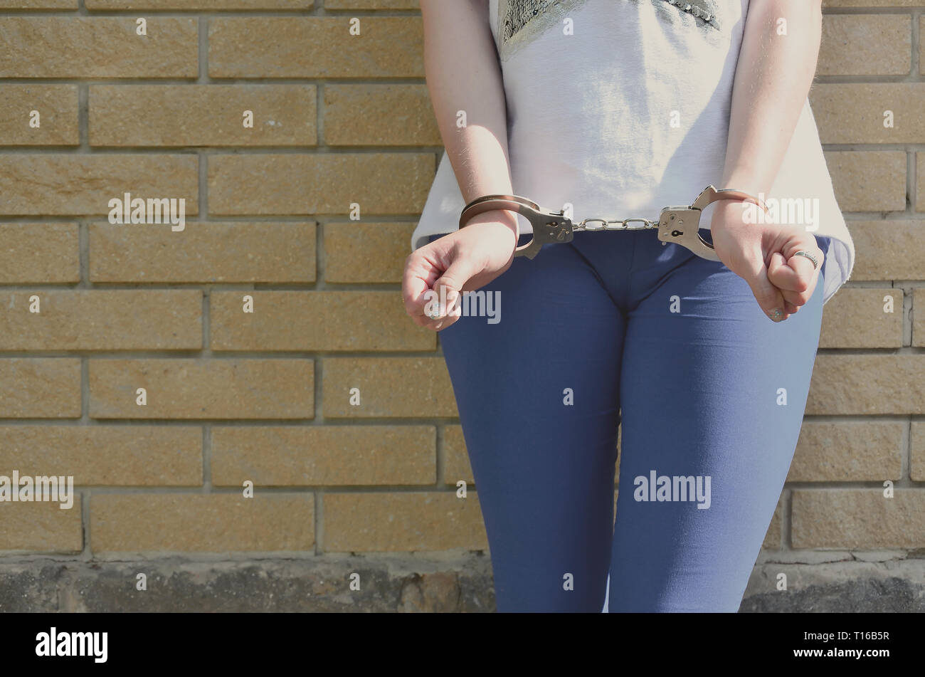 Woman handcuffed to wall hi-res stock photography and images - Alamy