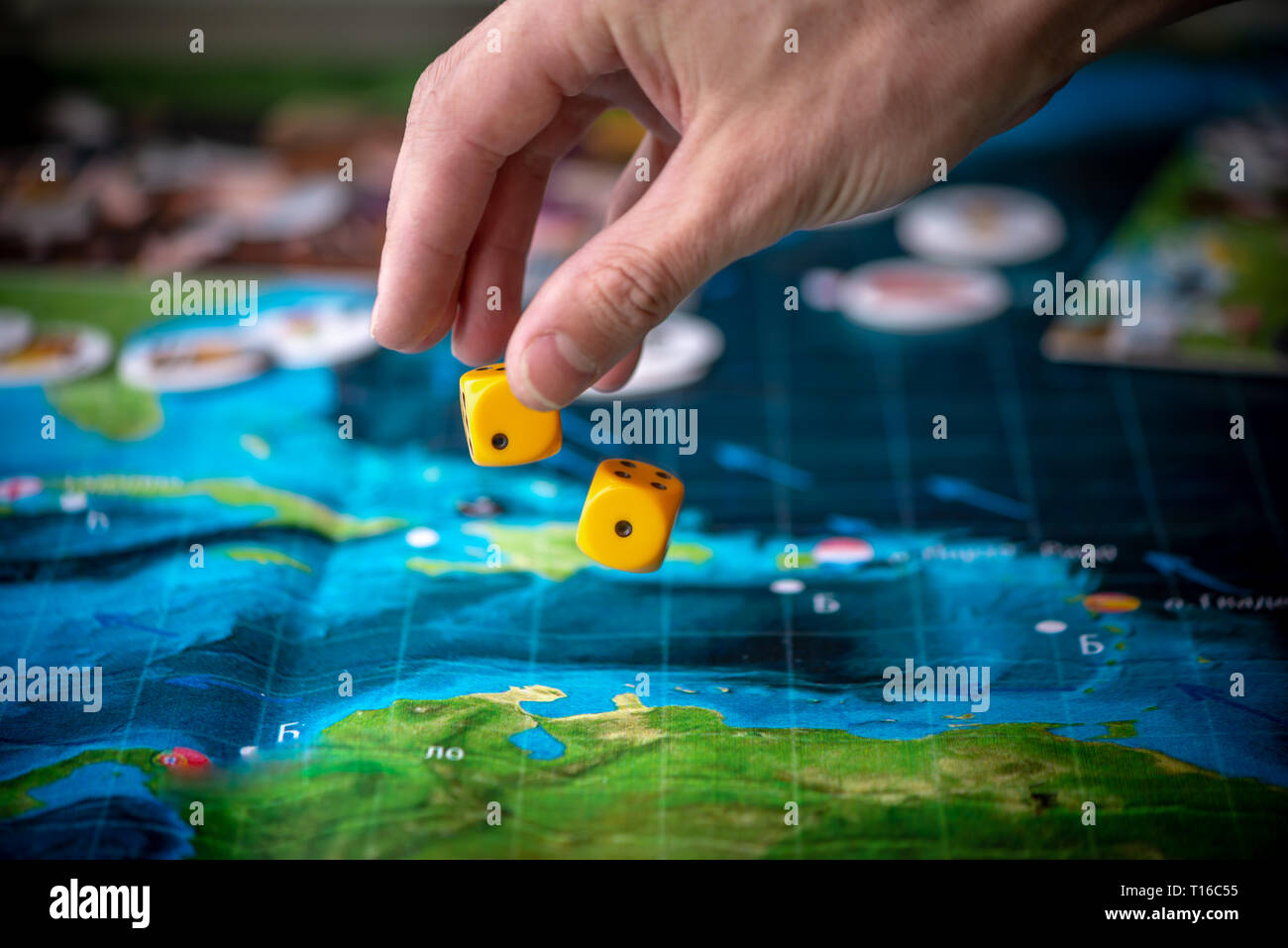 The hand throws two yellow dice on the playing field. Gaming moments in ...