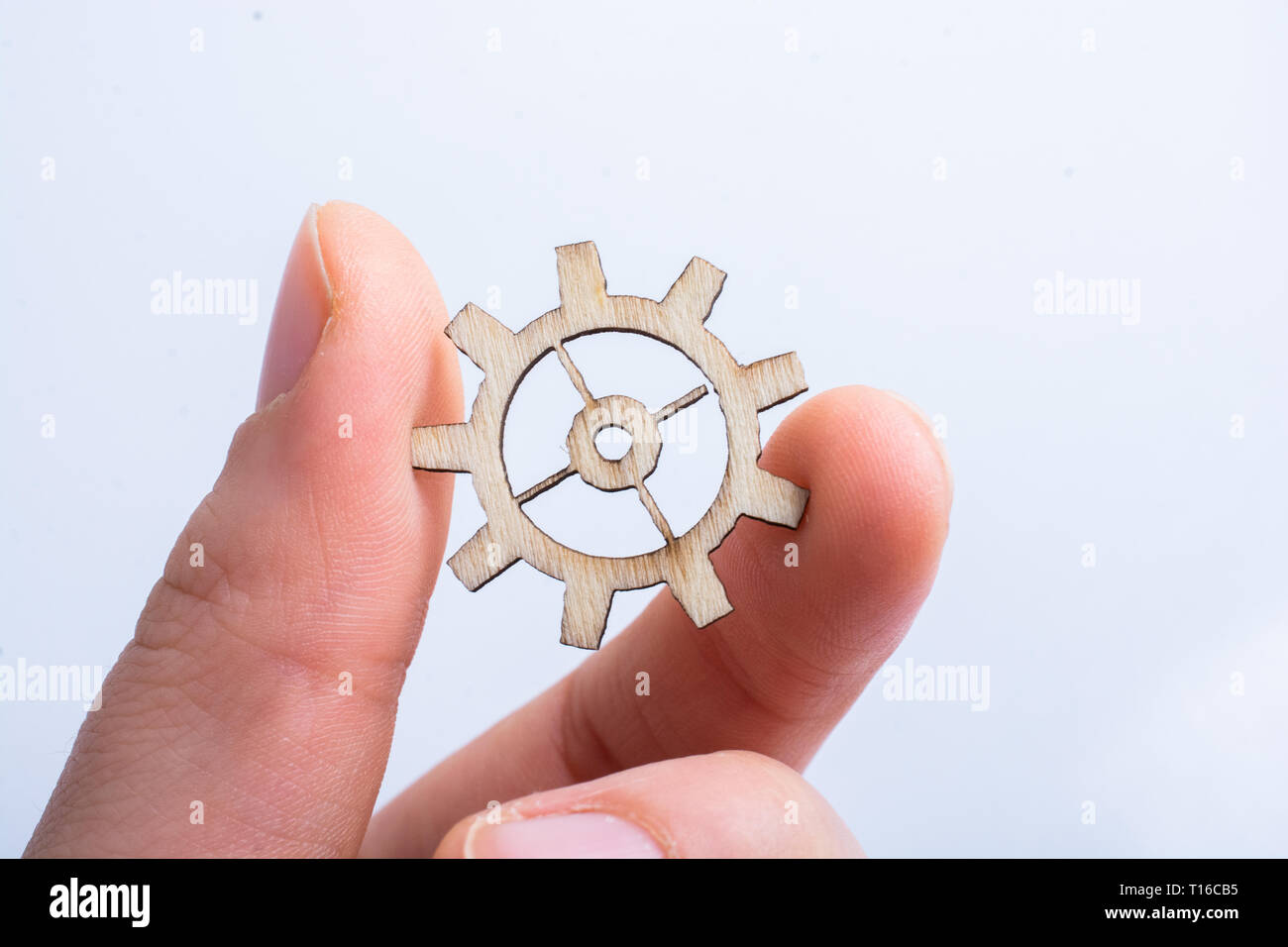 Hand holding gear wheels as the concept of mechanism Stock Photo - Alamy