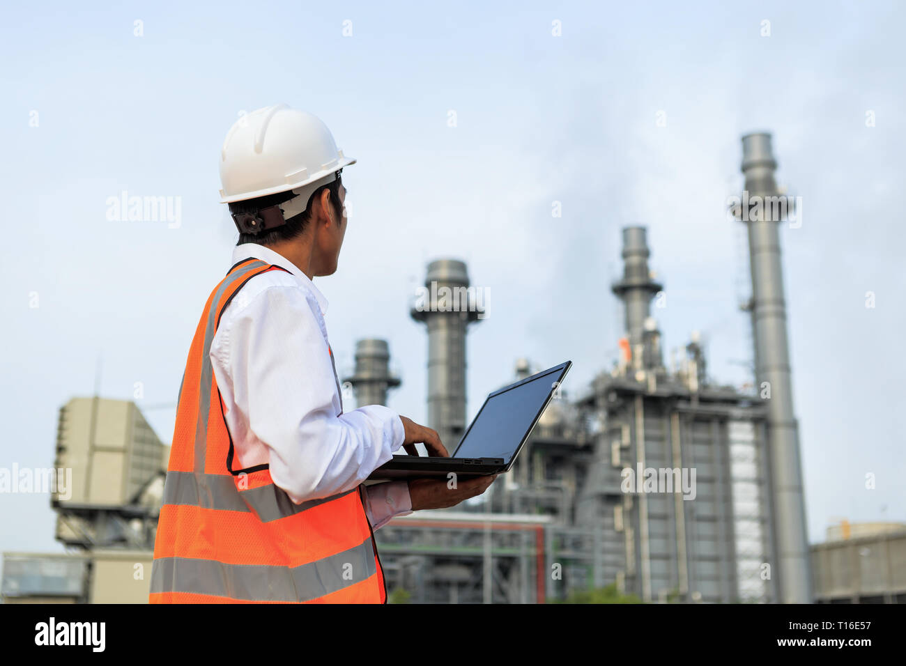 Engineer in uniform and helmet on of background the construction site ...