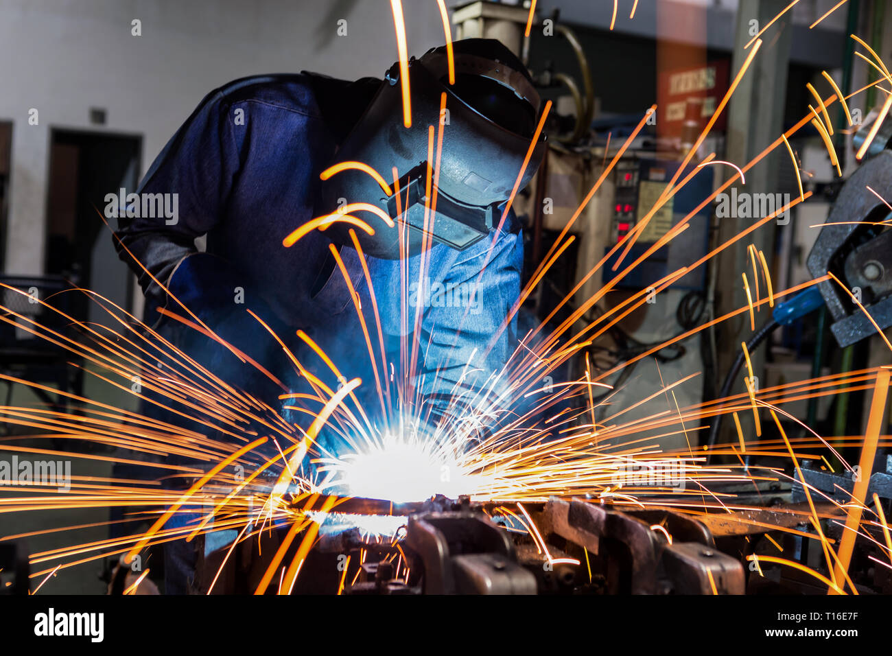 Worker is welding in factory Stock Photo - Alamy