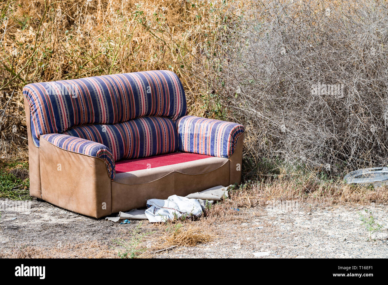 Sofa thrown away in natural area - forest part - illegal dumping trash ...