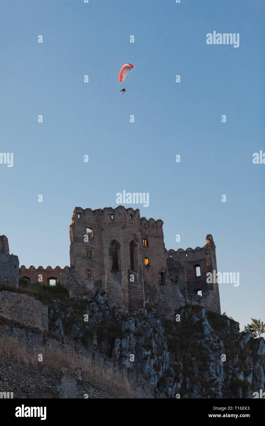 Para glider flying above ruined castle on the cliff. Motorized glider ...