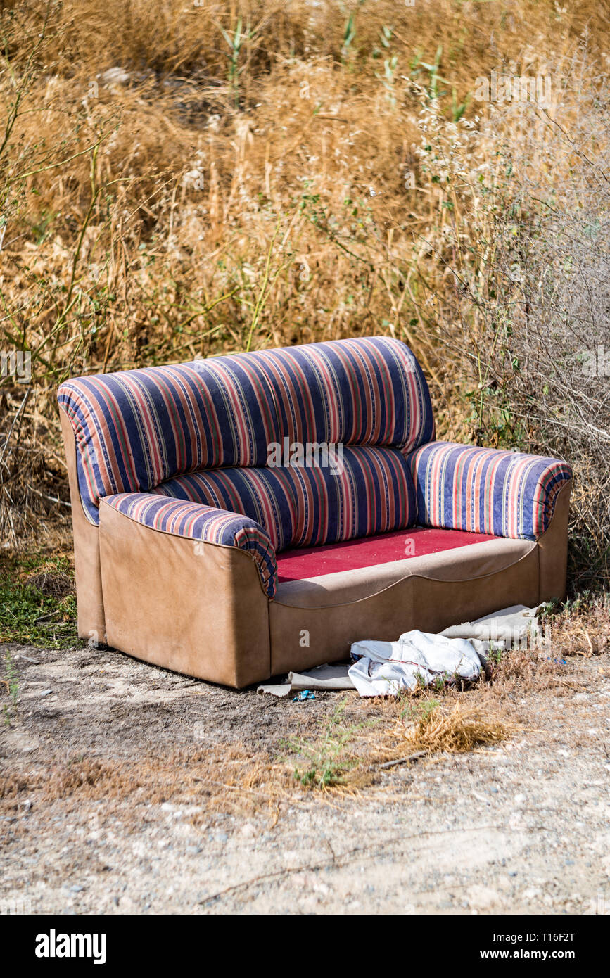 Sofa thrown away in natural area - forest part - illegal dumping trash ...