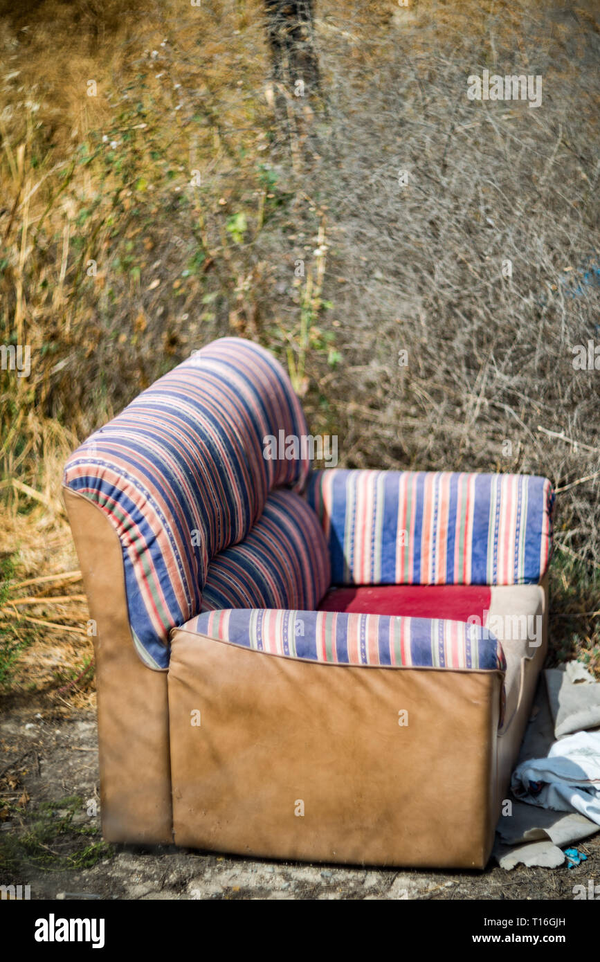 Sofa thrown away in natural area - forest part - illegal dumping trash ...