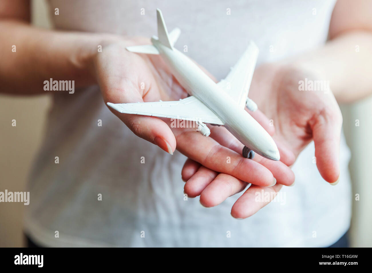 Female woman hands holding small toy model plane. Travel by plane ...
