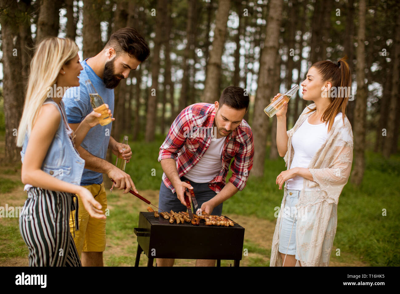 Group of young people enjoying barbecue party in the nature Stock Photo ...