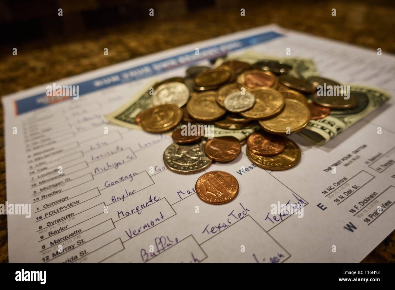 Money on top of a printed NCAA 2019 tournament bracket Stock Photo - Alamy