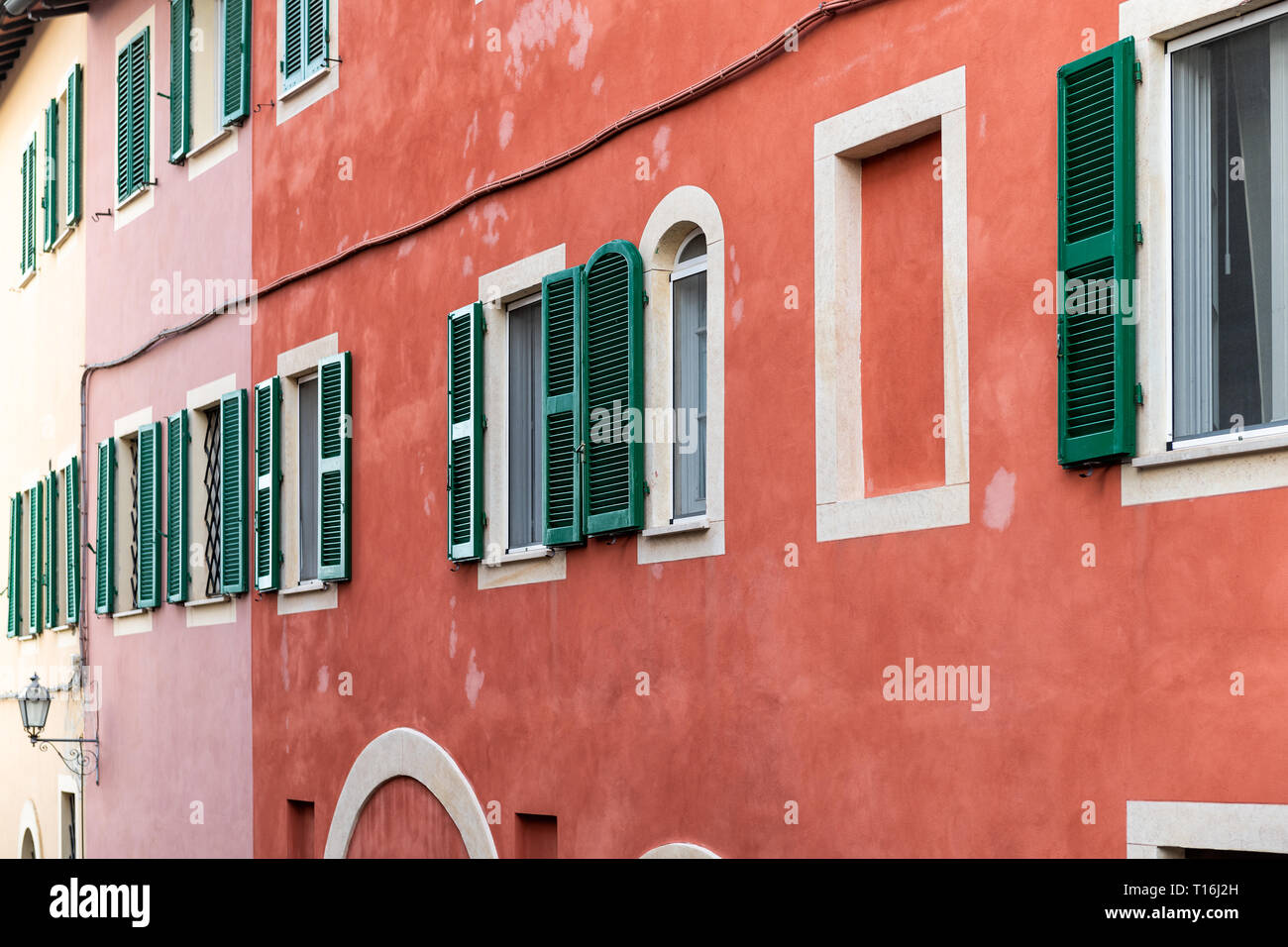 Chiusi, Italy red orange pink bright vibrant colorful walls street in ...