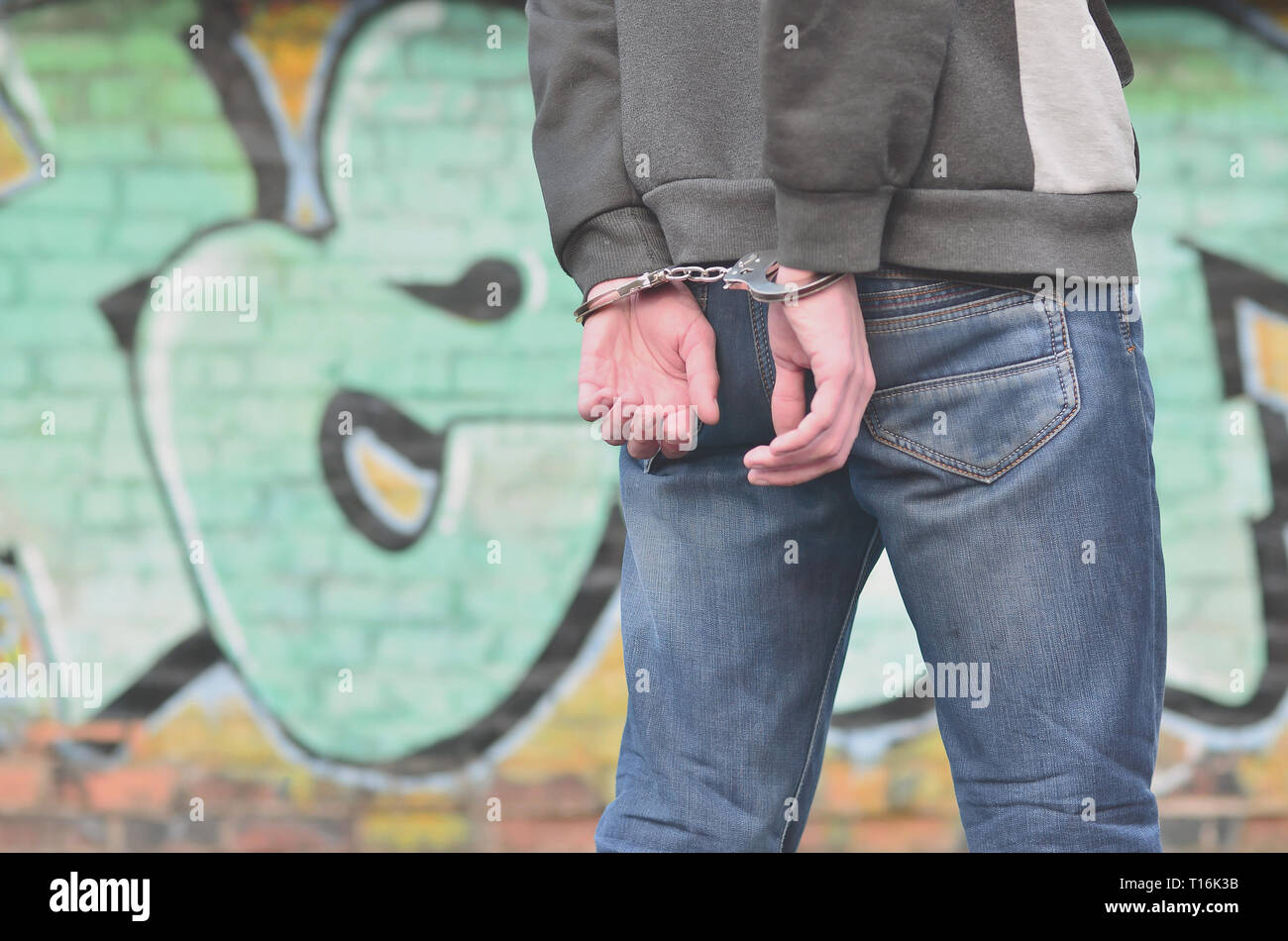 Back view of the arrested bandit from the ghetto against the background ...