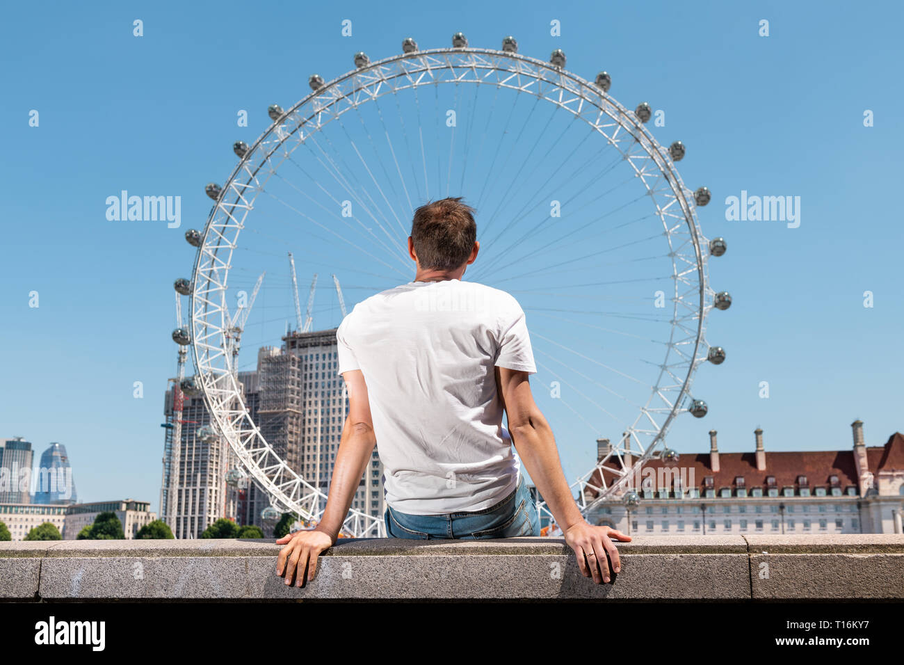 Man sitting on railing hi-res stock photography and images - Alamy