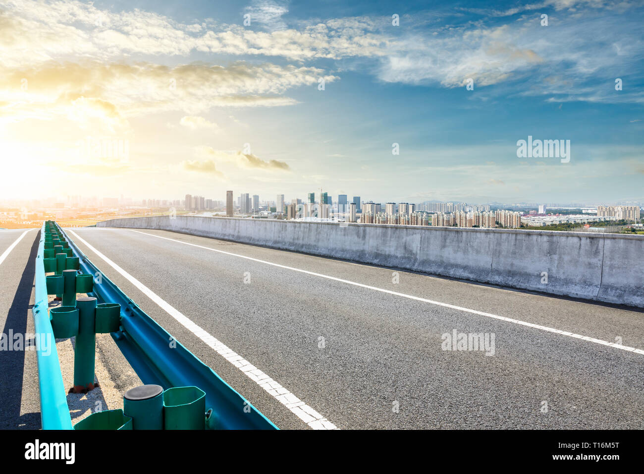 Asphalt highway passing through the city above in Shanghai at sunset ...