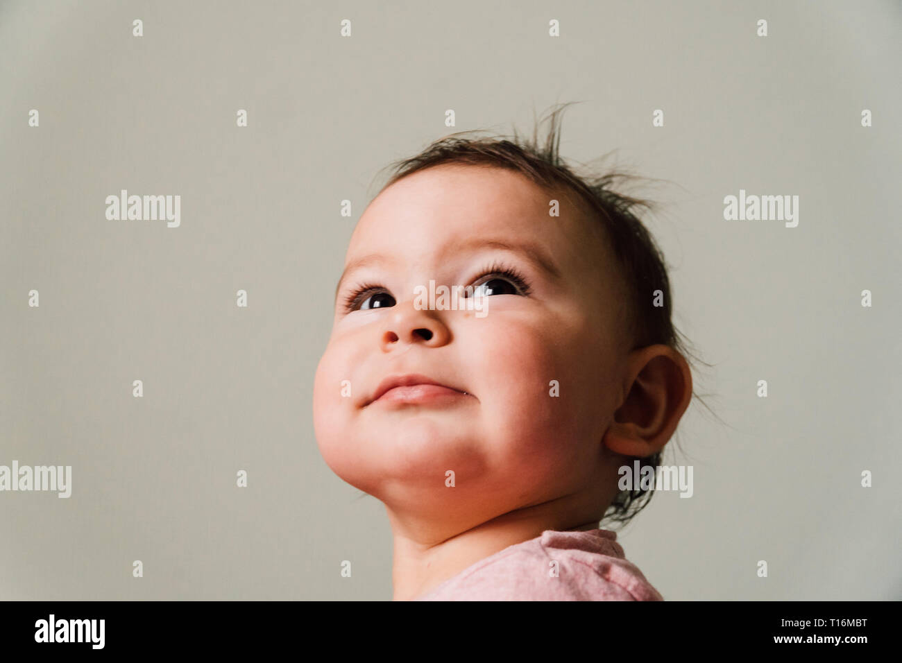 Cute baby looking up at home lifestyle Stock Photo - Alamy