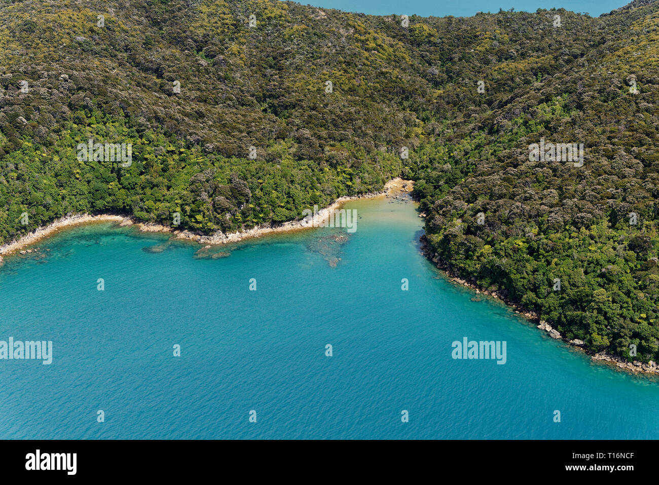 Blue sea leads into an inlet and bush clad hills Stock Photo - Alamy