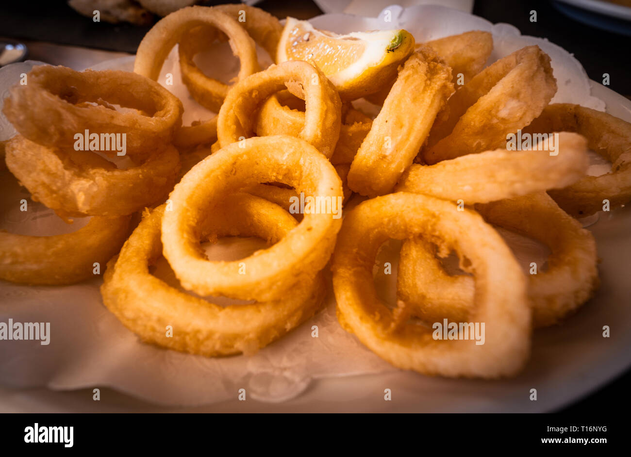 Spanish tapas: Plate of Roman-style squid or fried calamari with lemon ...