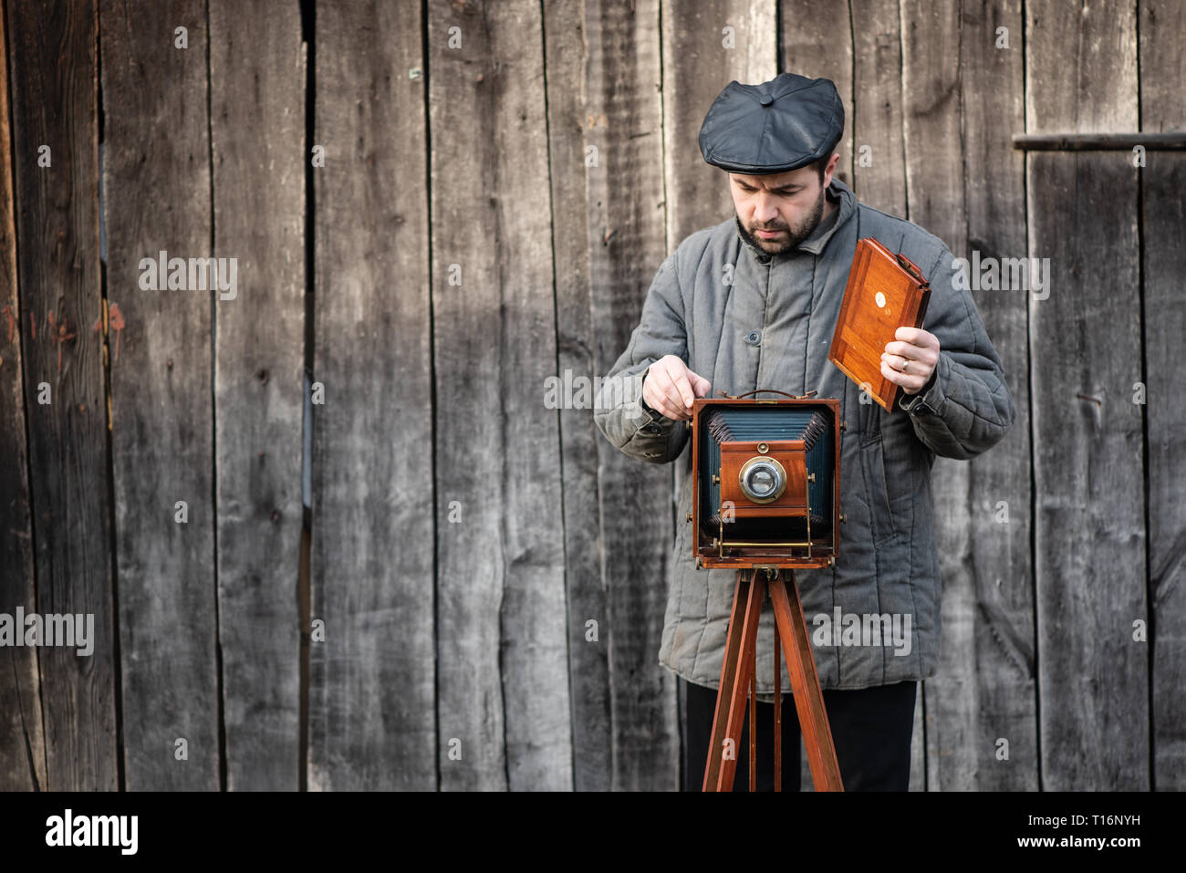 Photographer prepares for shooting and inserts film holder into retro ...