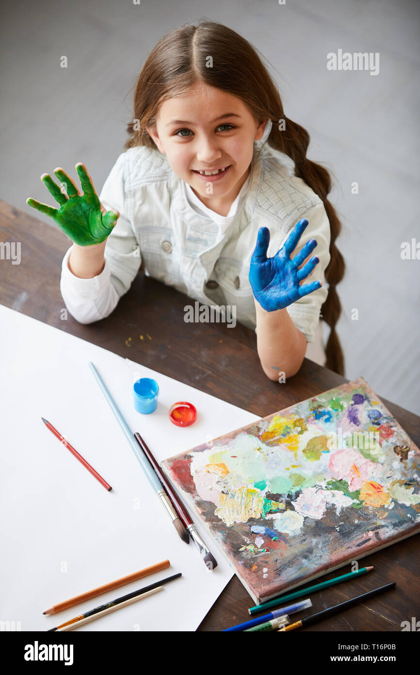 Cute Girl Enjoying painting Stock Photo - Alamy