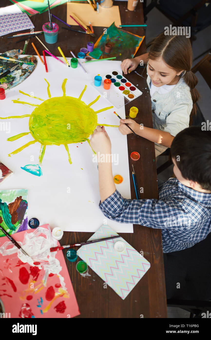 Two Kids Drawing Sun Stock Photo - Alamy