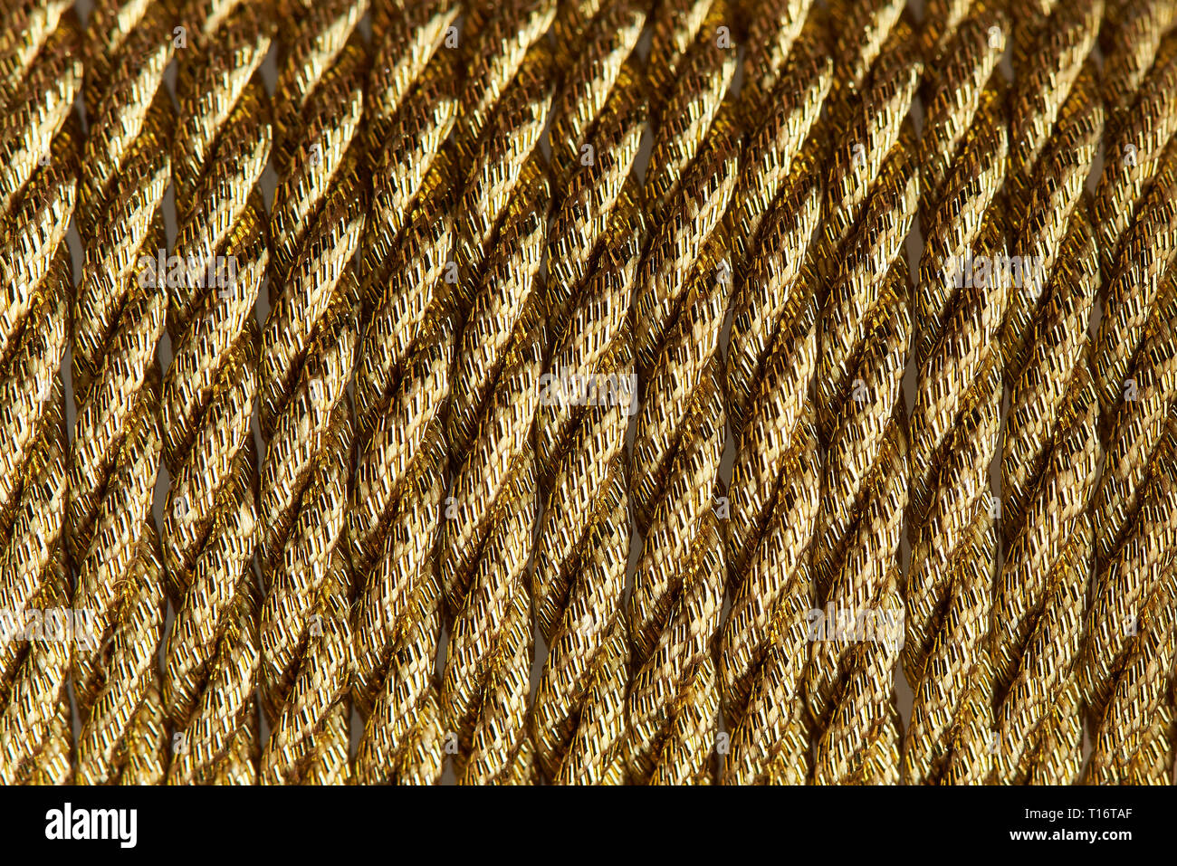 Background texture of gold twisted rope close-up Stock Photo - Alamy
