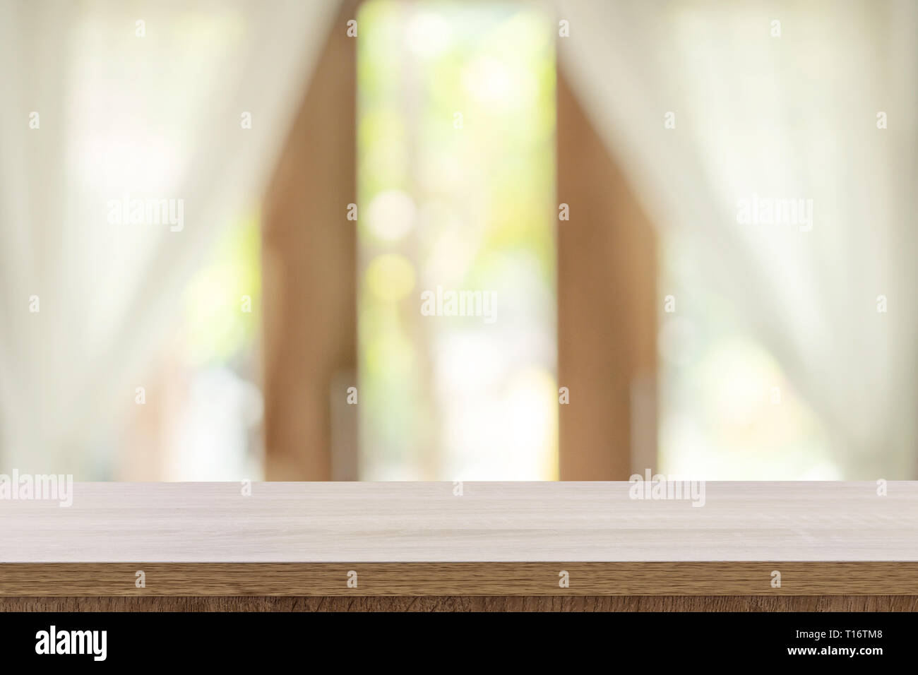 Empty wooden table and blur window background with copy space, display ...