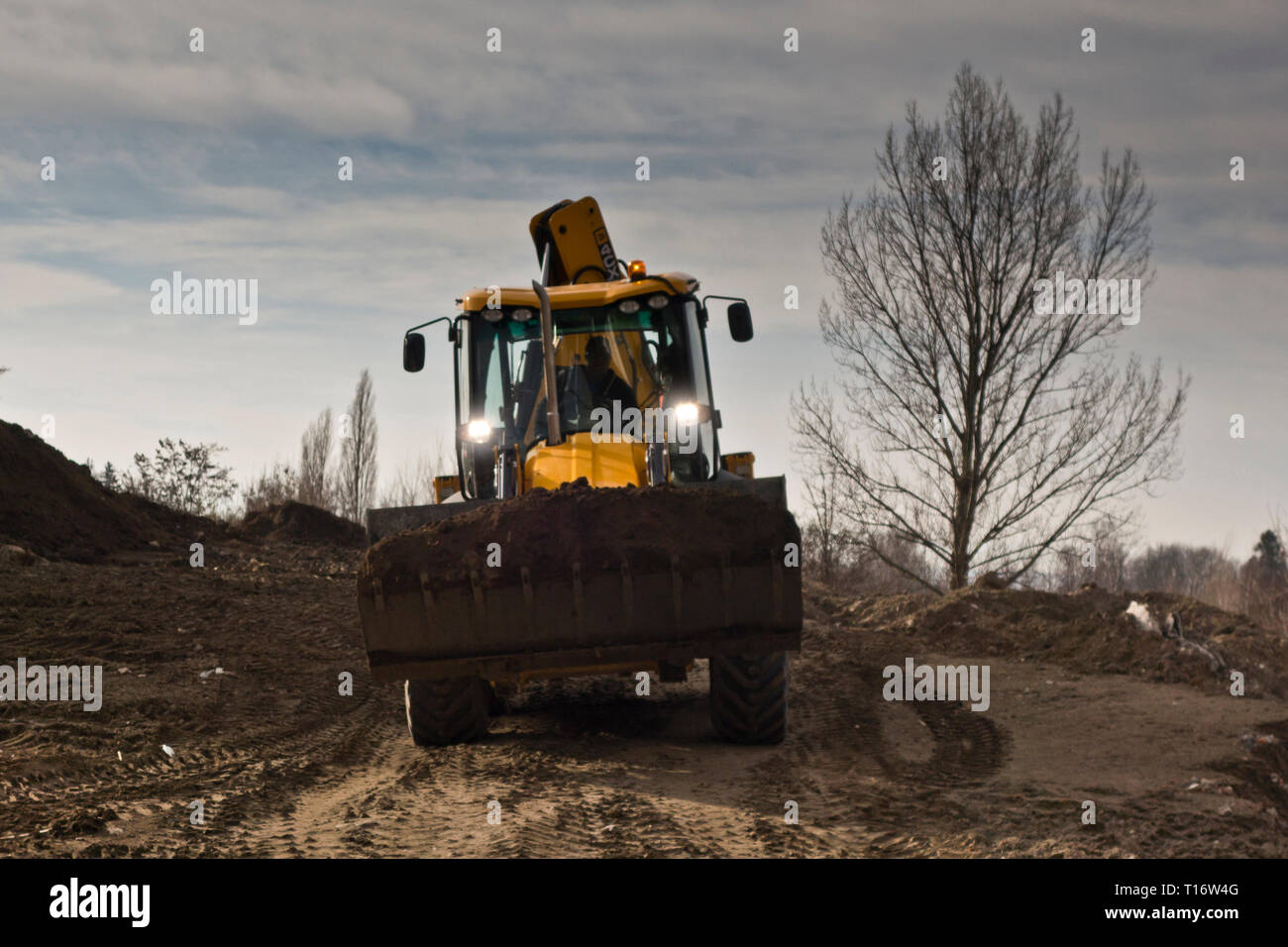excavator moving terrain in a construction site Stock Photo - Alamy