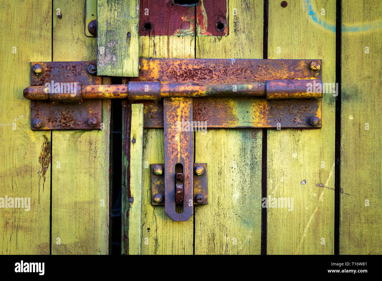 Old yellow wooden plank door with padlock. Architecture detail ...