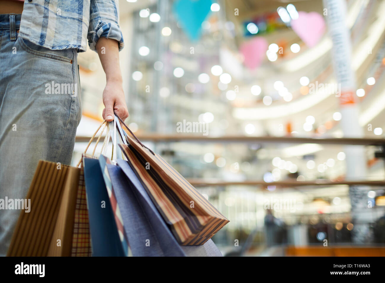 Carrying shopping bags in mall Stock Photo - Alamy