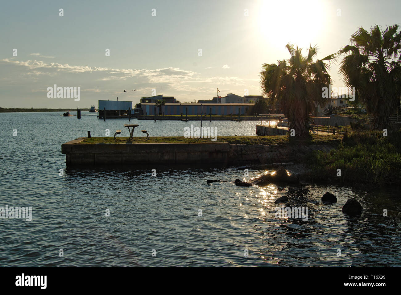 Sunset on the lake or ocean shore Stock Photo - Alamy