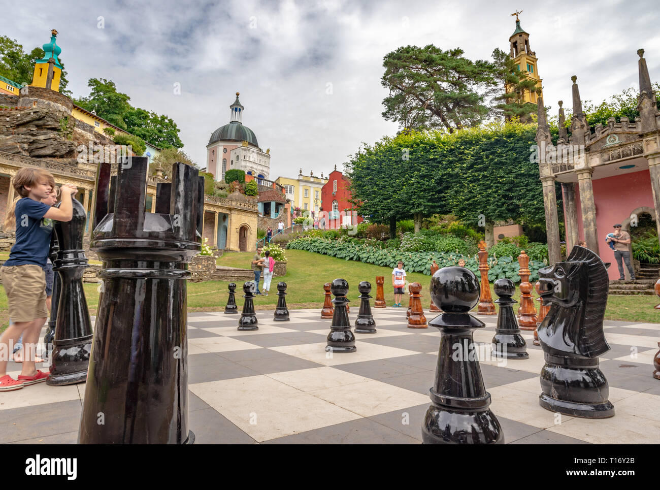 Kids playing with giant chess pieces in the village center, Portmeirion ...