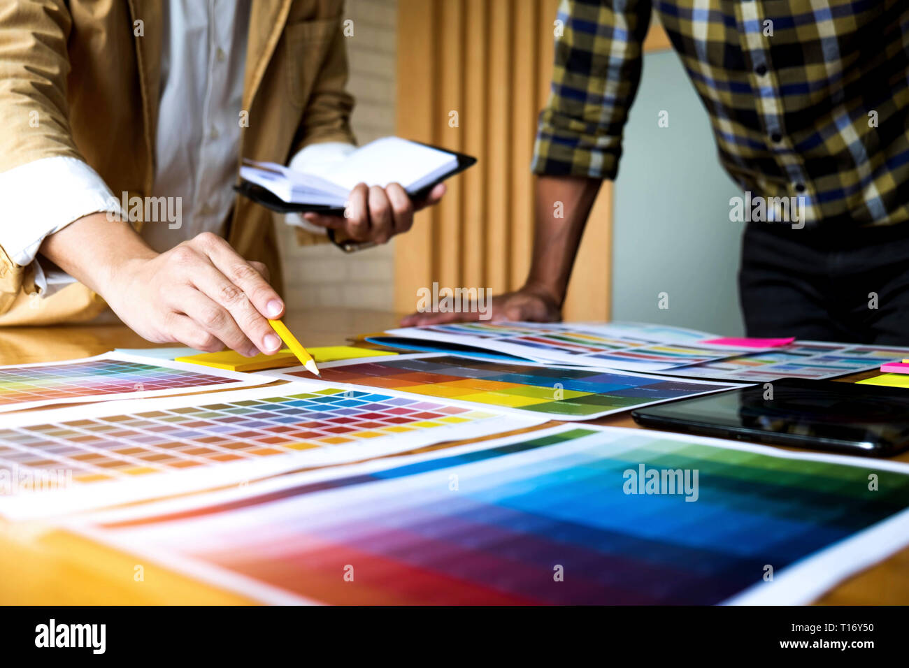 Graphic designers choose colors from the color bands samples for design ...