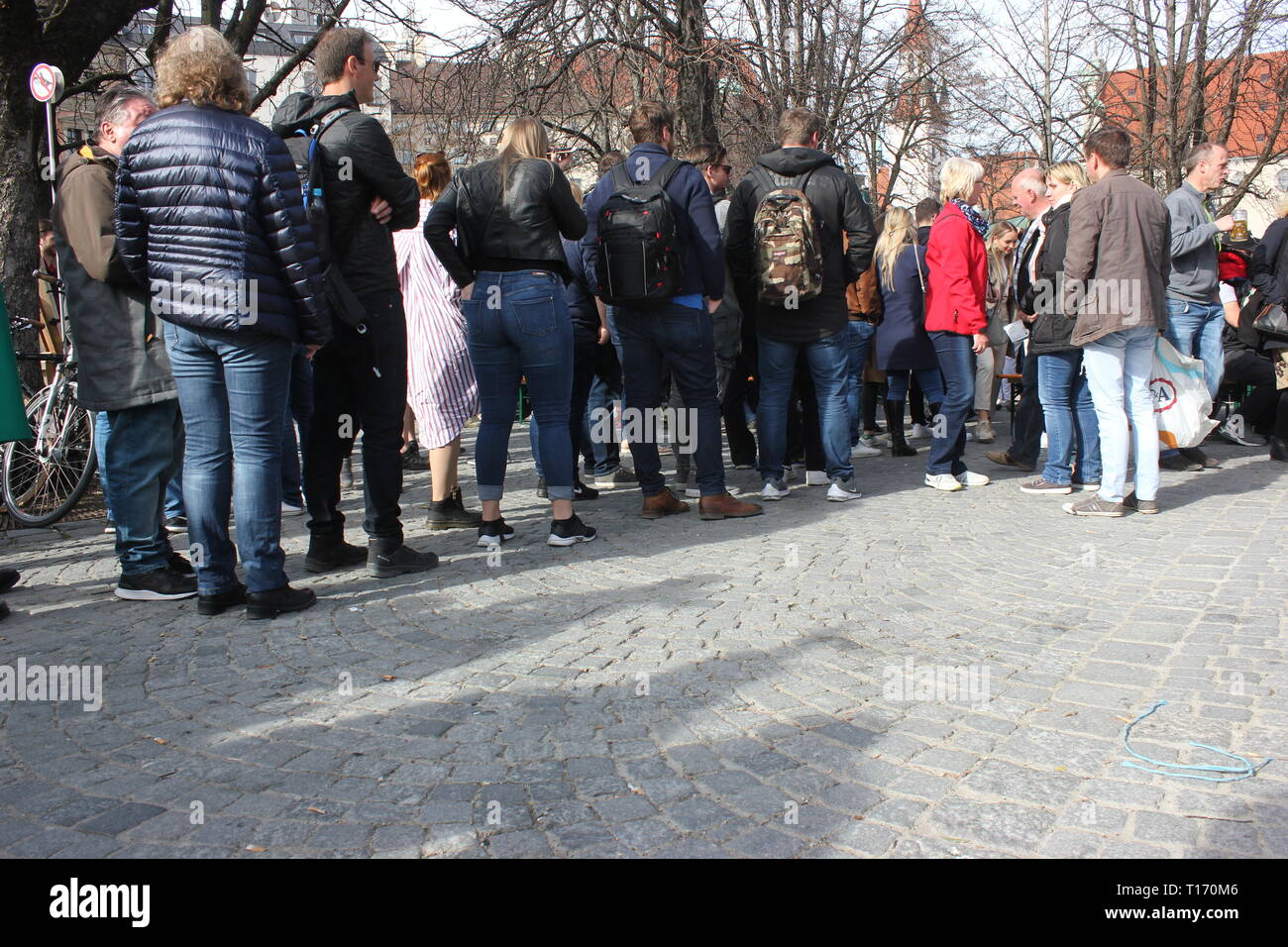 People lining up outside for free beer in beer garden, Munich ...