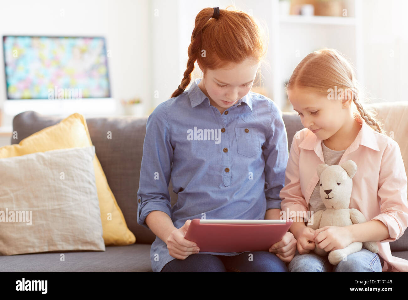 Two Children using Digital Tablet Stock Photo - Alamy