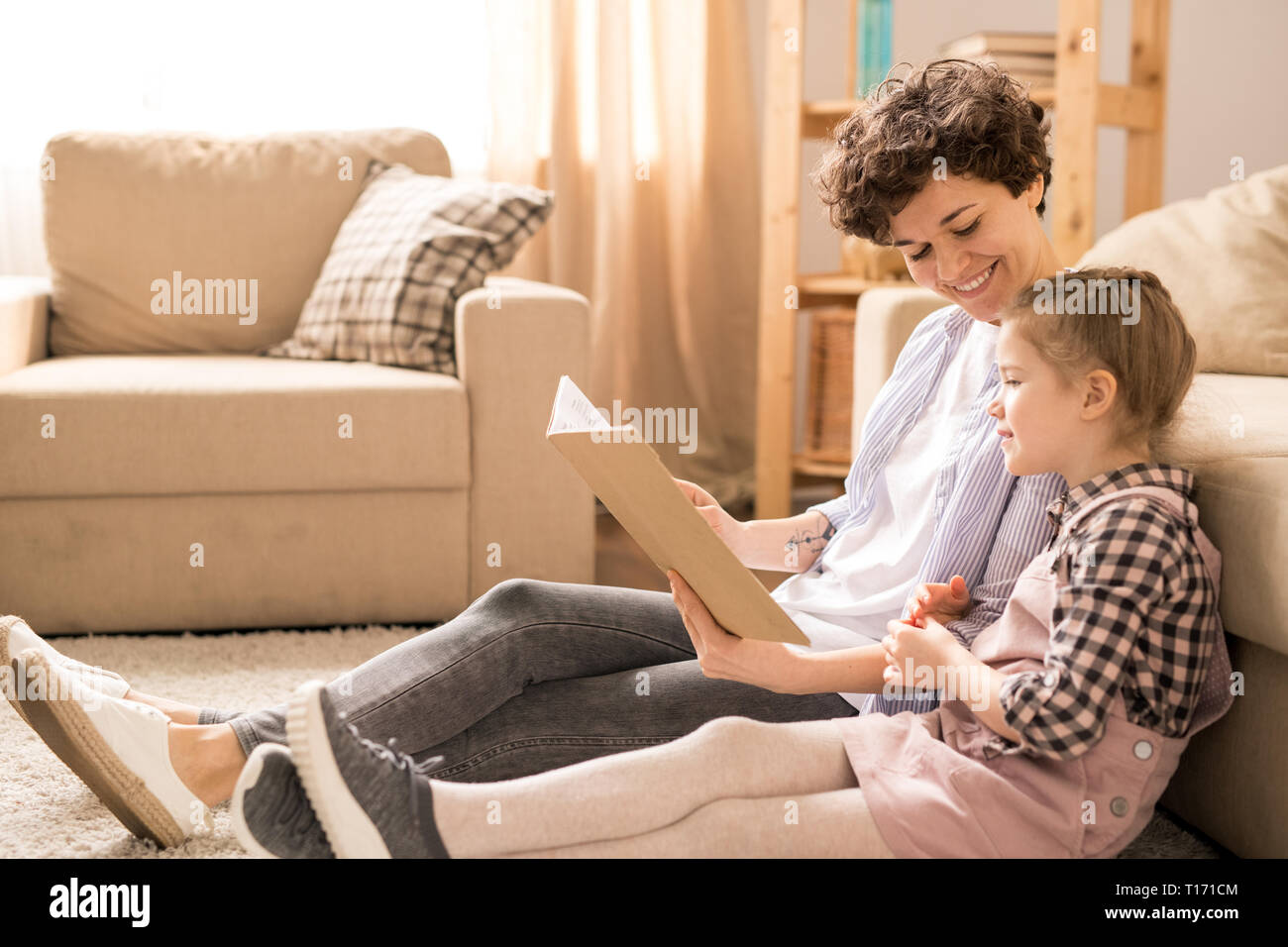 Reading story together Stock Photo - Alamy