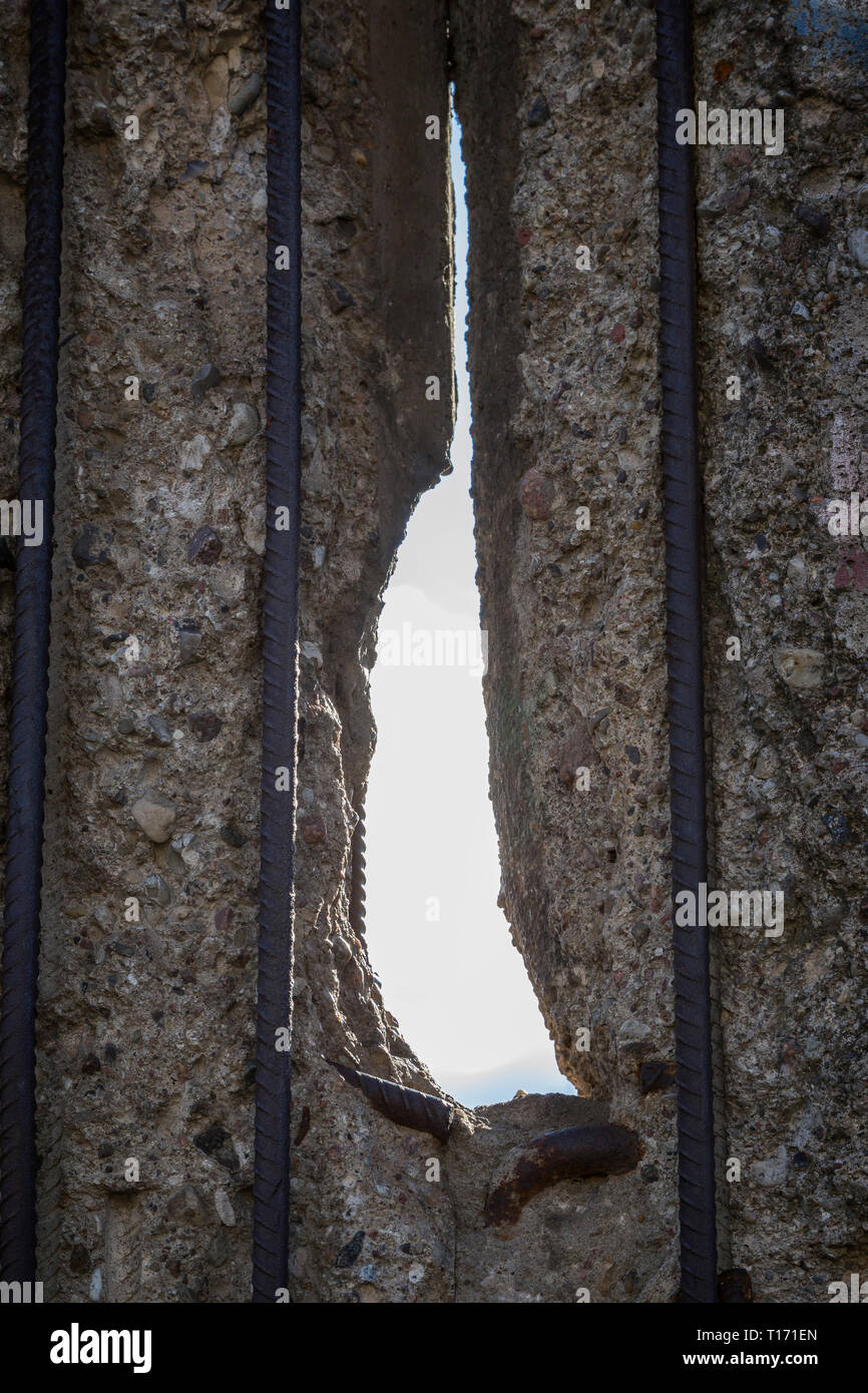 Rusty metal rods and a hole at the weathered and damaged Berlin Wall ...
